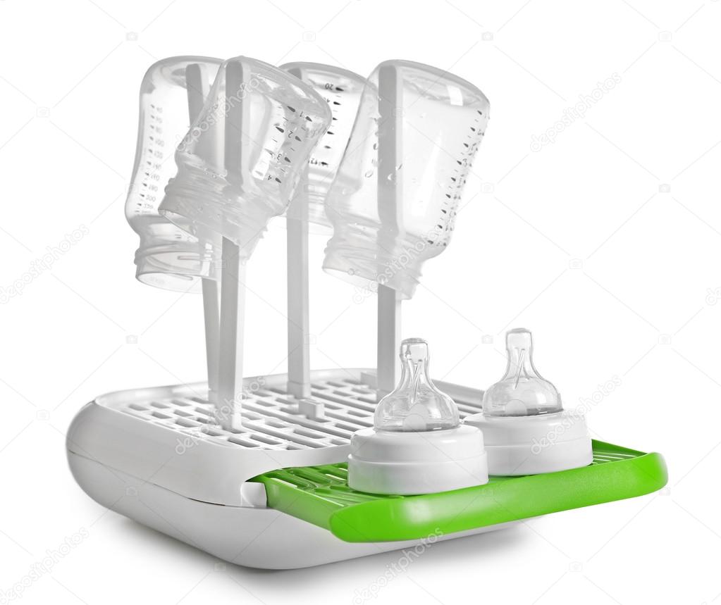 Baby bottles on plastic drying rack Stock Photo by ©belchonock 117472596
