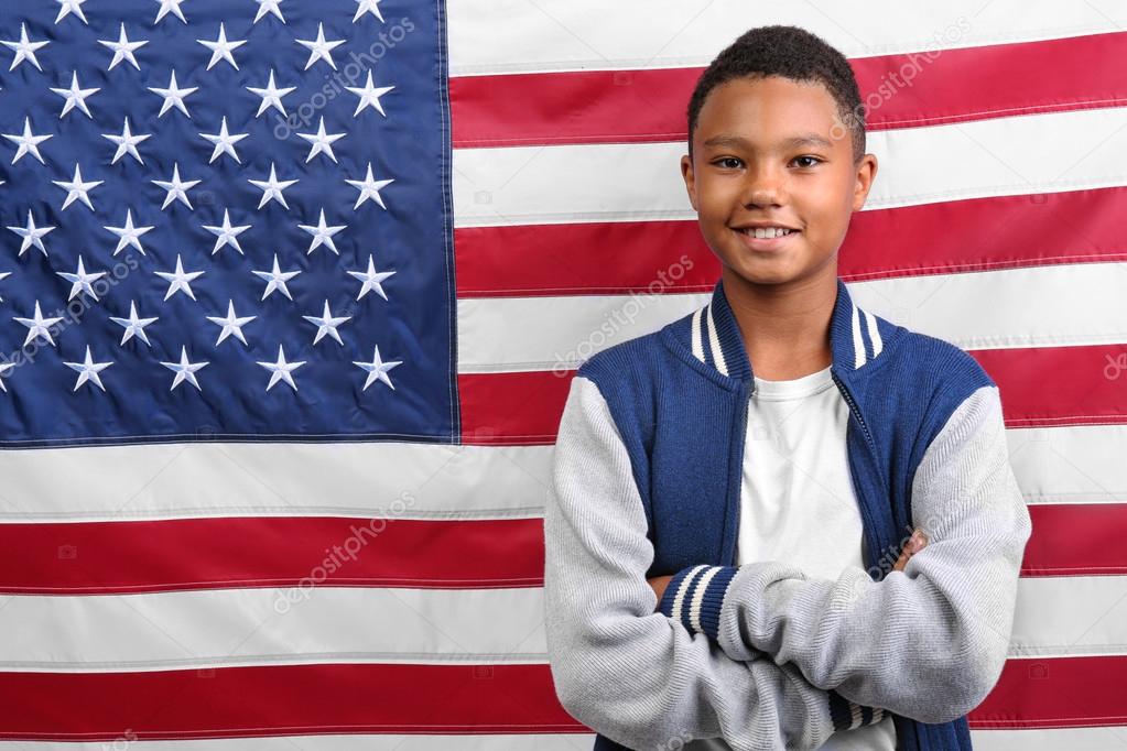 Boy on American flag Stock Photo by ©belchonock 119856220