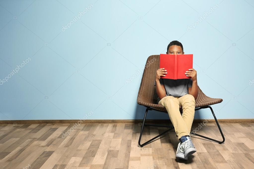 Cute boy reading book Stock Photo by ©belchonock 120440234