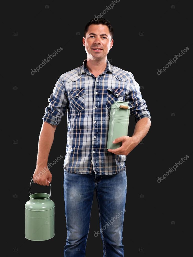 Handsome milkman on dark background Stock Photo by ©belchonock 121442368