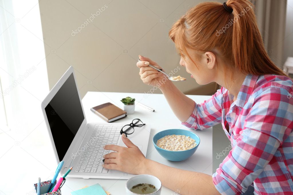 Beautiful Girl Eating Front Computer Stock Photo by ©belchonock 121842384