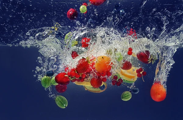 Vegetables and fruits falling into water — Stock Photo © belchonock ...