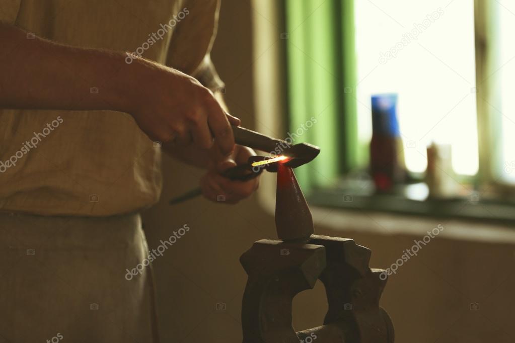 Smith working with iron Stock Photo by ©belchonock 122455858