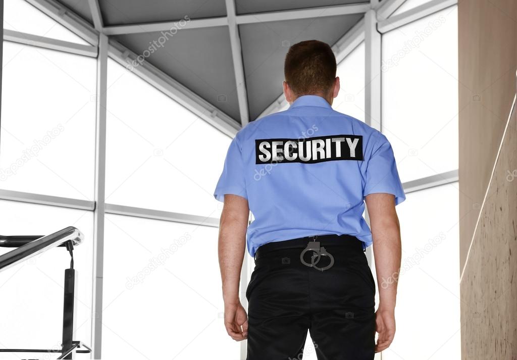Security man standing back Stock Photo by ©belchonock 123884934