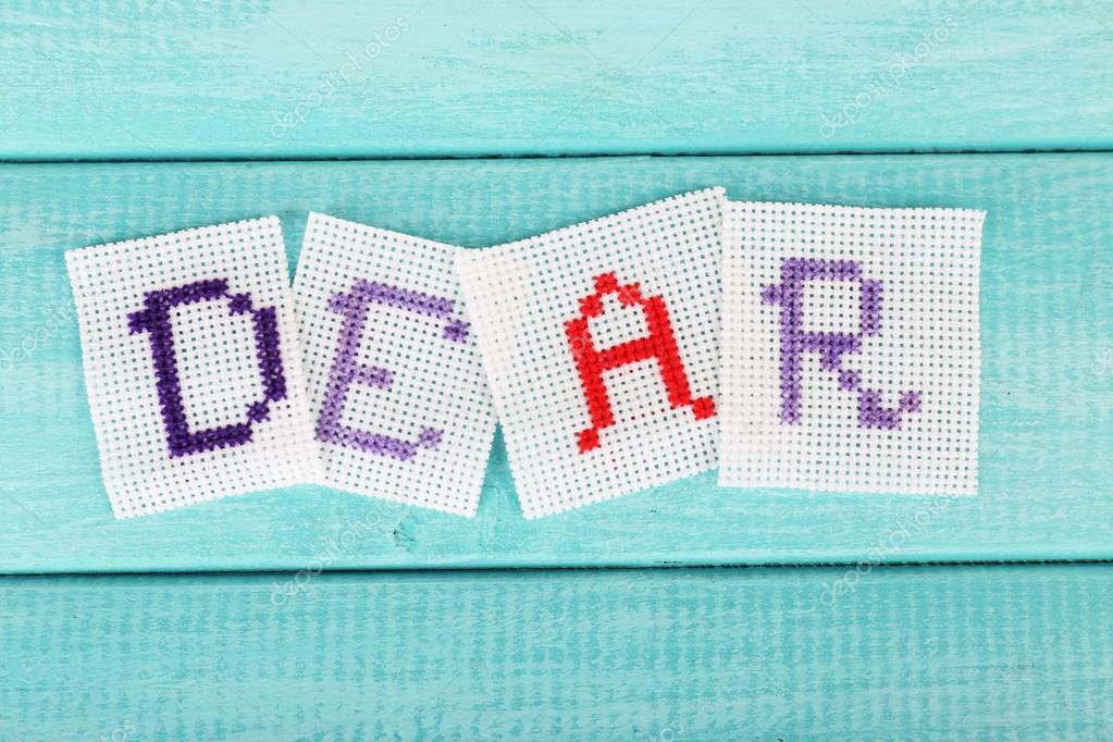 Word made from embroidered letters — Stock Photo © belchonock #52528497
