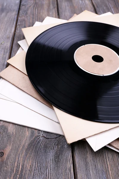Vinyl records records and paper covers on wooden background Stock Photo ...