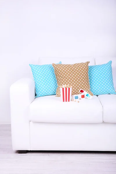 Popcorn and ball on sofa Stock Photo by ©belchonock 54032709
