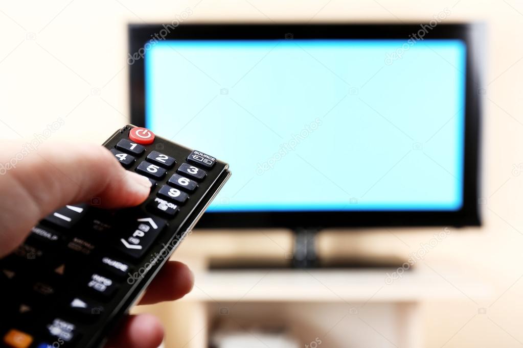 TV and using remote controller — Stock Photo © belchonock #54038775