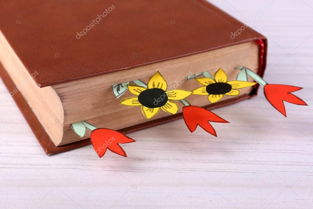 Book with bookmarks on wood — Stock Photo © belchonock #54251403