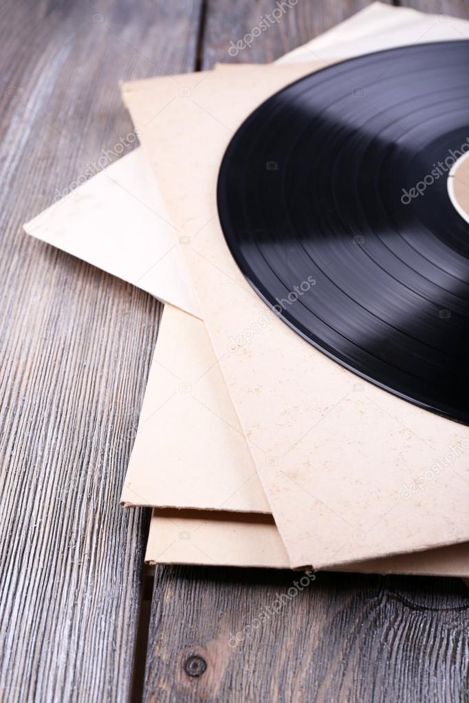 Vinyl records records and paper covers on wooden background Stock Photo ...