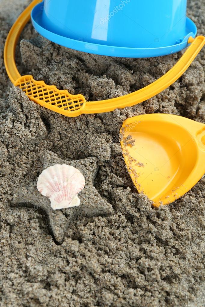 Spade and bucket on beach Stock Photo by ©belchonock 55735823