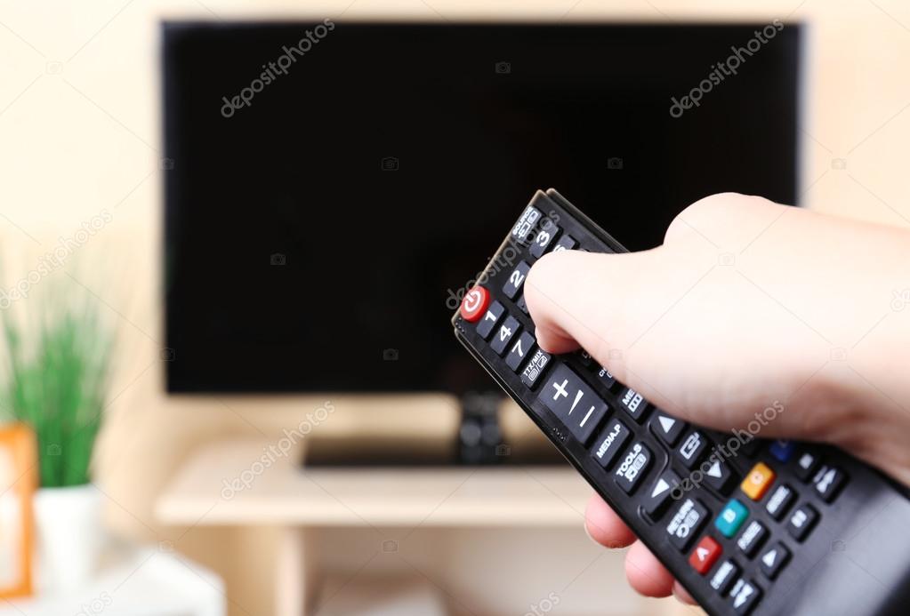Watching TV and using remote controller — Stock Photo © belchonock ...