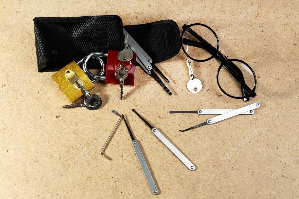 Set of locks, keys and lock picks on wooden background Stock Photo by ...