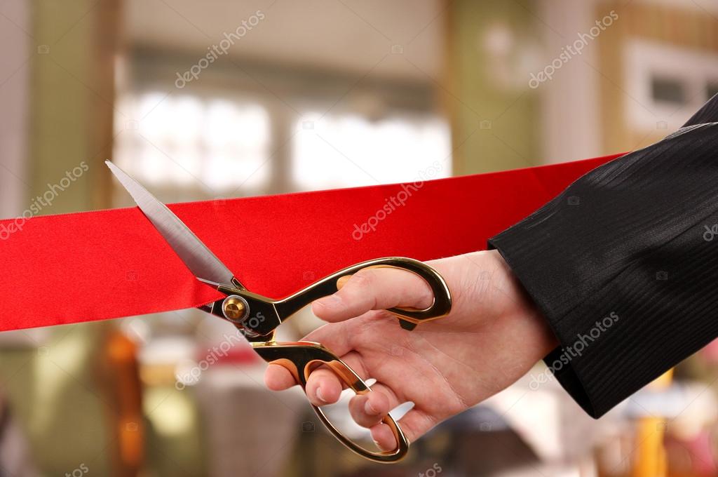 Grand opening, hand cutting red ribbon — Stock Photo © belchonock #60923435