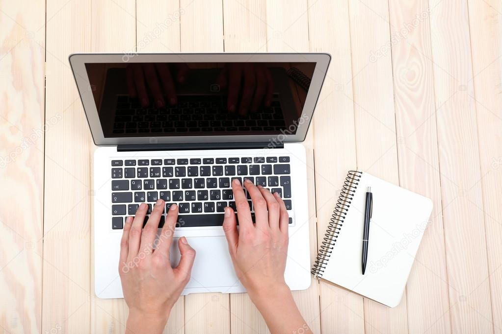 Person using notebook Stock Photo by ©belchonock 61078353