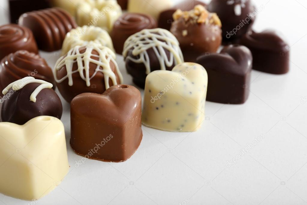Delicious chocolate candies isolated on white Stock Photo by ...