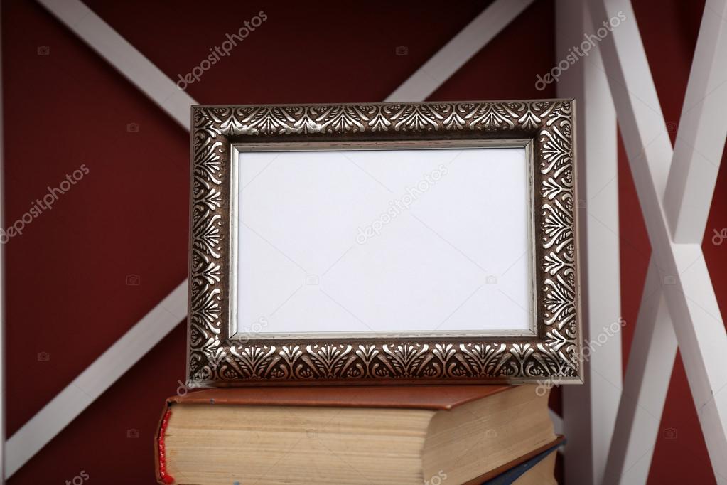 Photo frame with books on shelf, on color wall background — Stock Photo ...