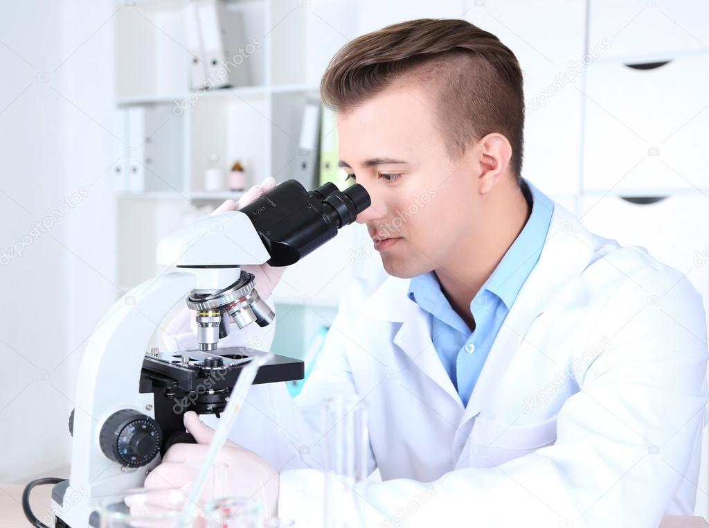 Male scientist using microscope in laboratory Stock Photo by ... Male scientist using microscope in laboratory Stock Photo by ...