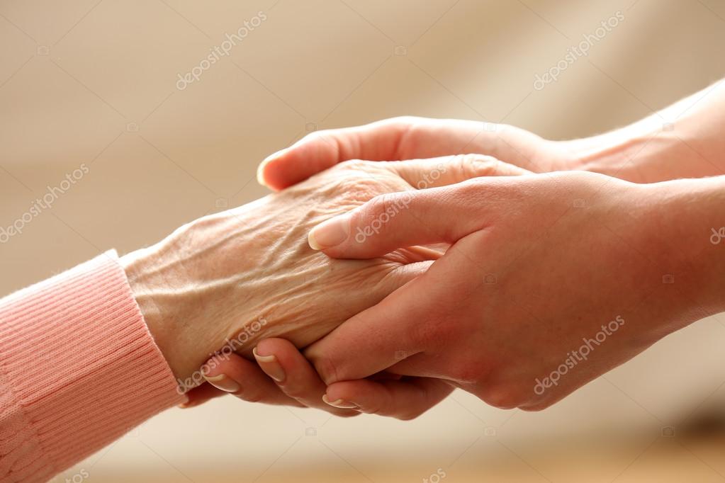 Old and young holding hands on light background, closeup — Stock Photo ...