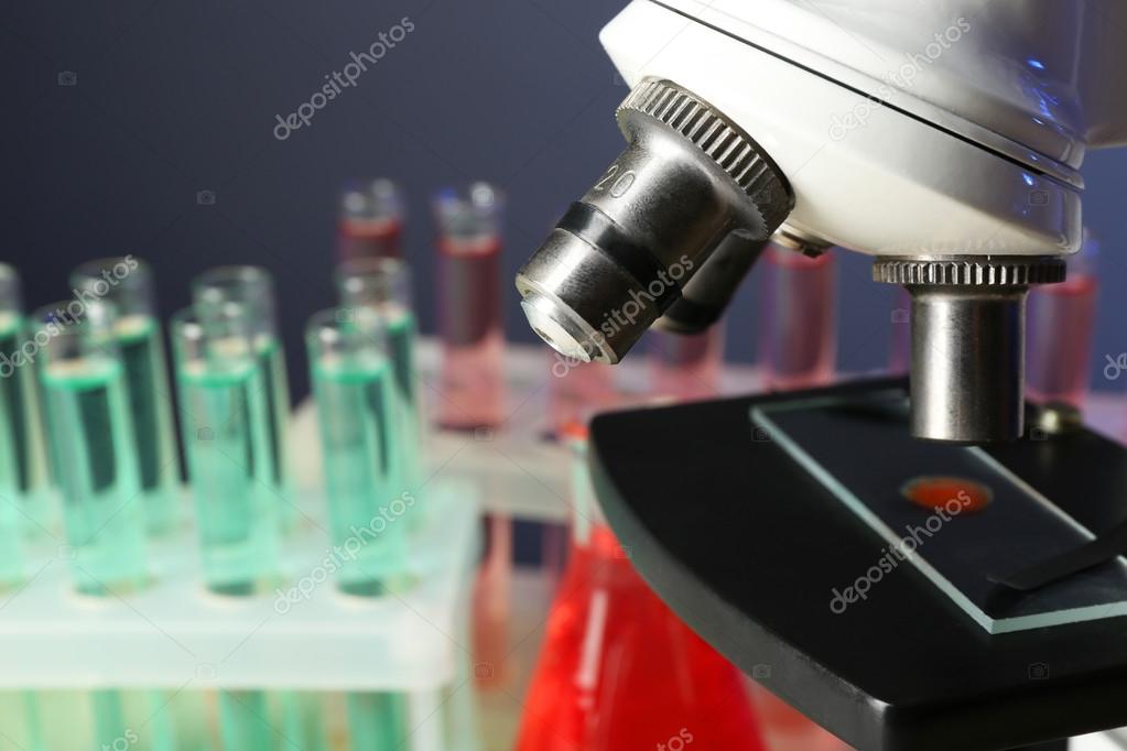 Microscope on test tubes background Stock Photo by ©belchonock 63958063