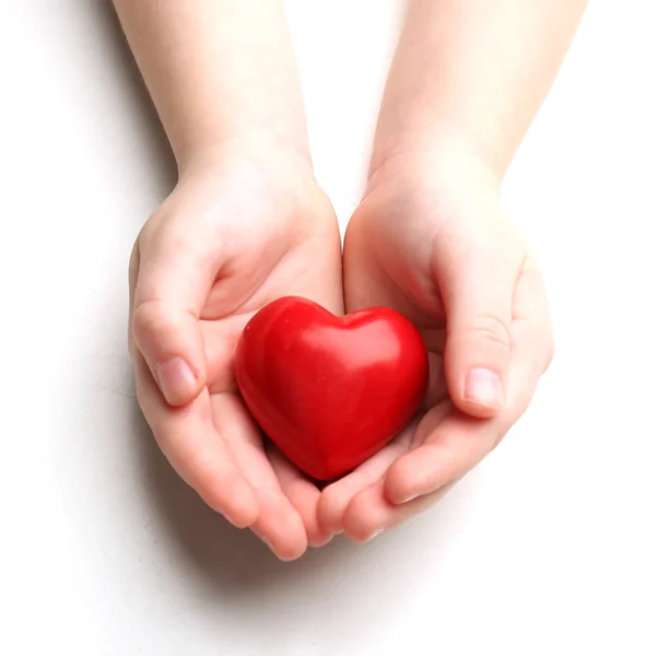 Heart in child hands — Stock Photo © belchonock #64714395
