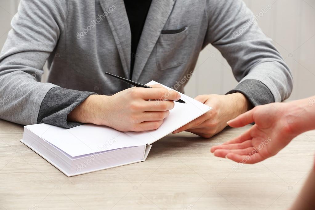 Author signing autograph in book Stock Photo by ©belchonock 65019617