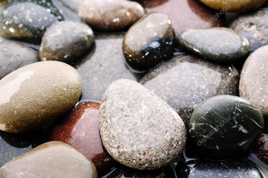 Wet sea pebbles, macro view — Stock Photo © belchonock #65346419
