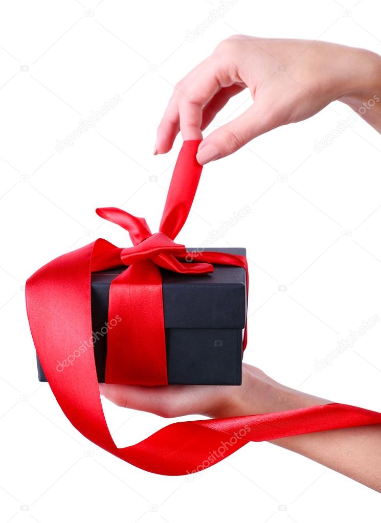 Woman's hand holding ribbon and opening gift box isolated on white ...