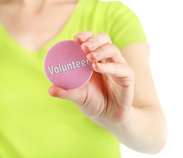 Round volunteer button in hand close-up Stock Photo by ©belchonock 67940569