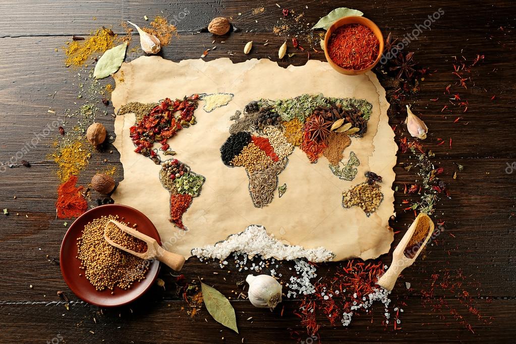 Map of world made from different kinds of spices on wooden background ...