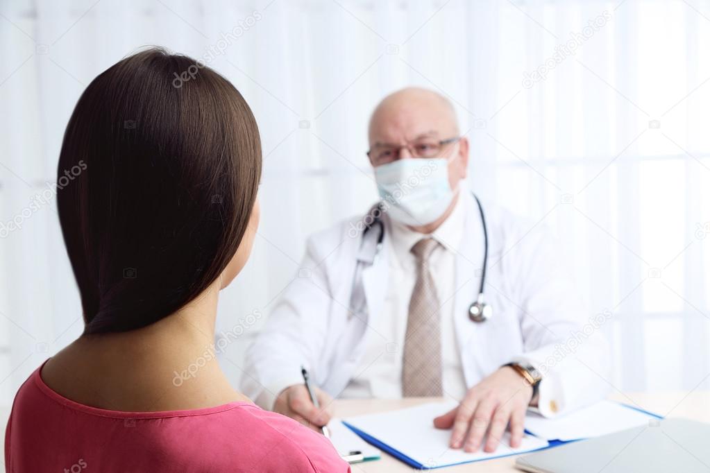 Professional doctor receiving patient in his office on white curtain ...