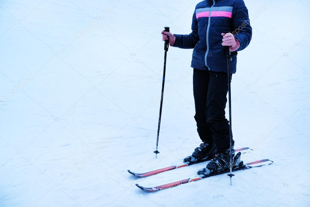 Human legs with skis over white snow background Stock Photo by ...