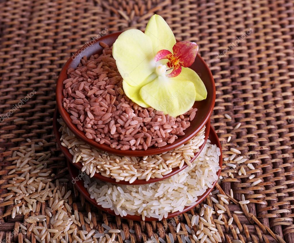 Different types of rice in bowls on wicker background Stock Photo by ...