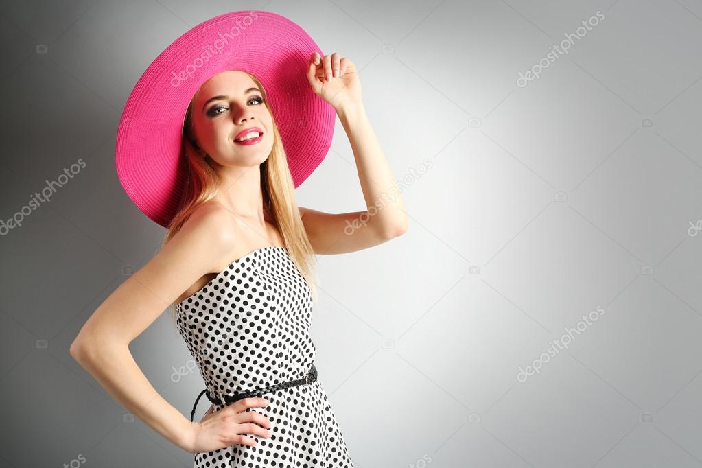 Expressive young model in pink hat on gray background Stock Photo by ...