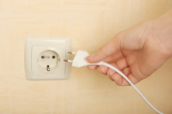 Hand putting plug in electricity socket — Stock Photo © belchonock ...