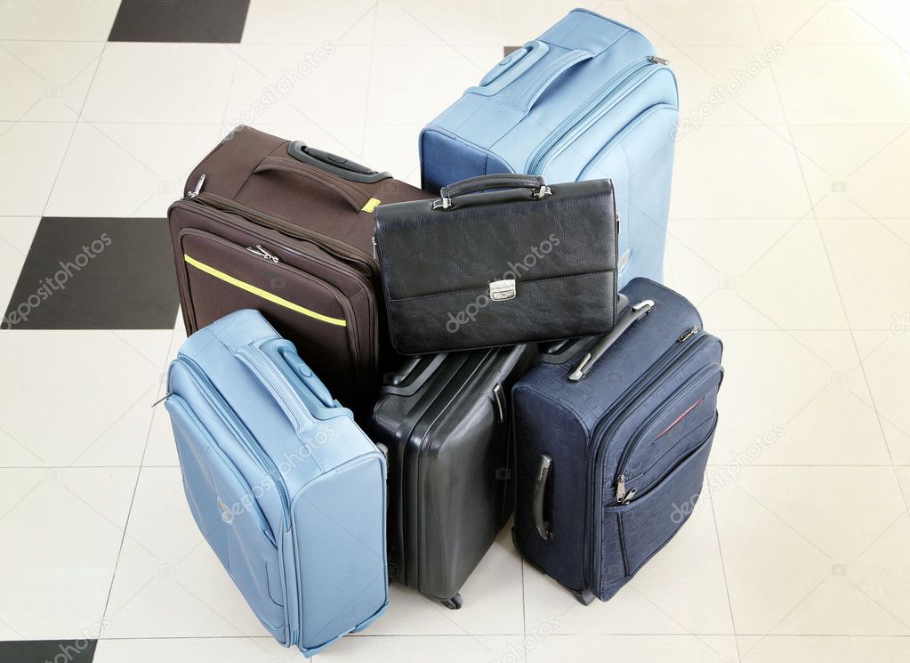Group of suitcases on floor background — Stock Photo © belchonock #71229279
