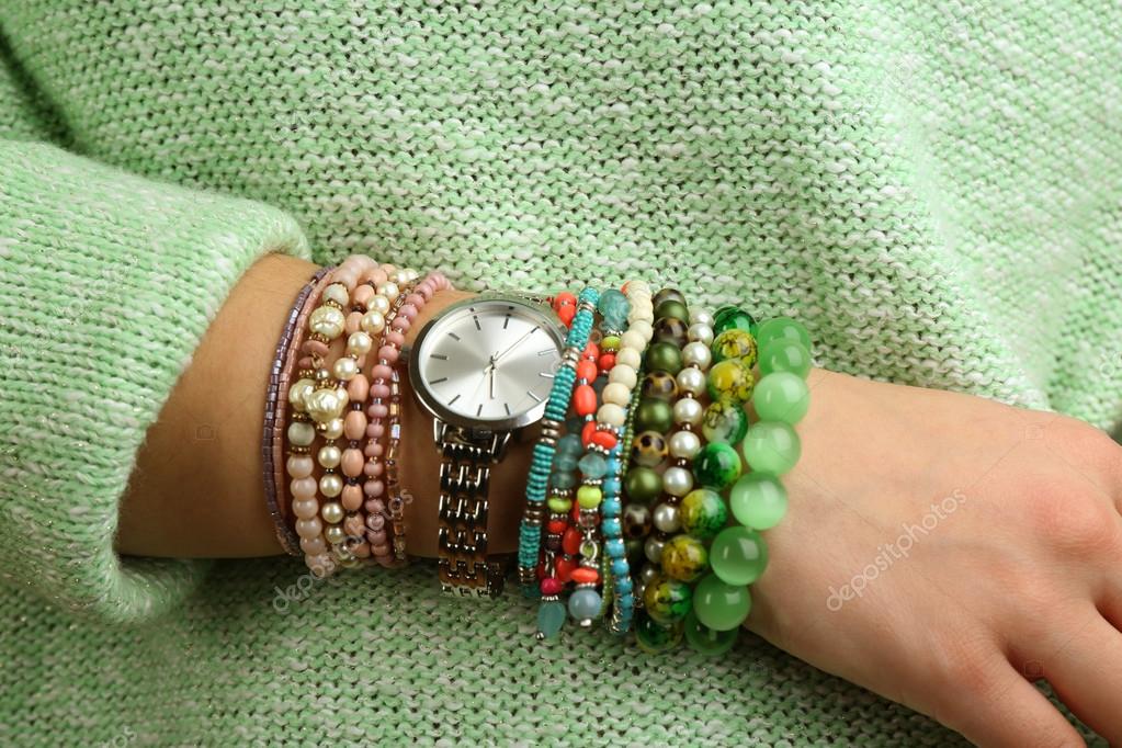 Stylish bracelets and clock on female hand close-up — Stock Photo ...