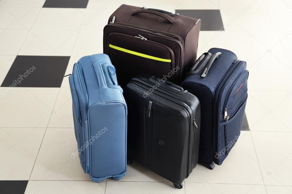 Group of suitcases on floor background — Stock Photo © belchonock #71562159