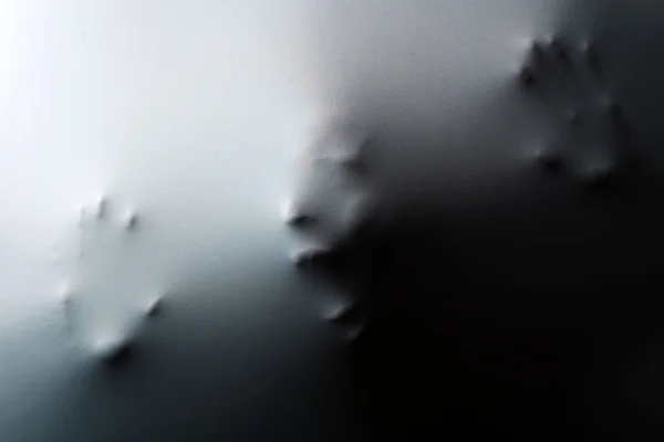 Screaming human face with hands pressing through fabric as horror ...