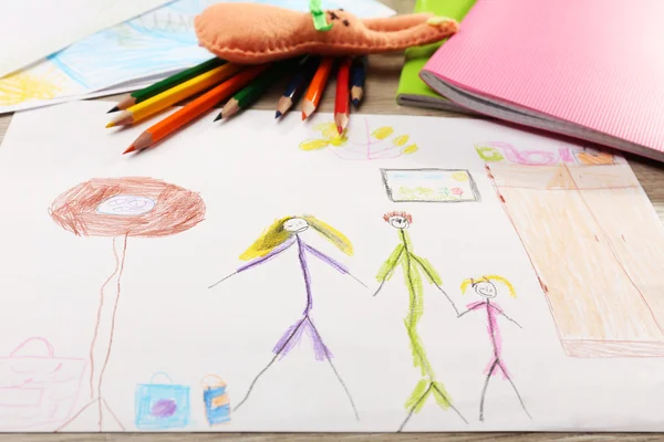 Kids drawing on white sheet of paper on wooden table, top view Stock ...