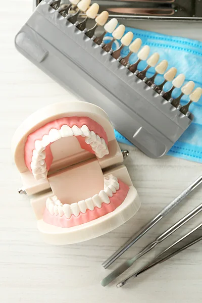 White teeth and dental instruments on table background — Stock Photo ...