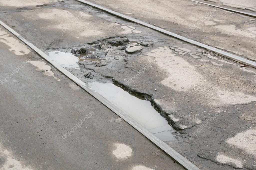 Very bad quality road with potholes and puddles Stock Photo by ...