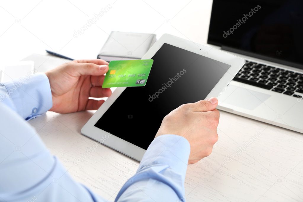 Man holding credit card and tablet — Stock Photo © belchonock #79069712 Man holding credit card and tablet — Stock Photo © belchonock #79069712