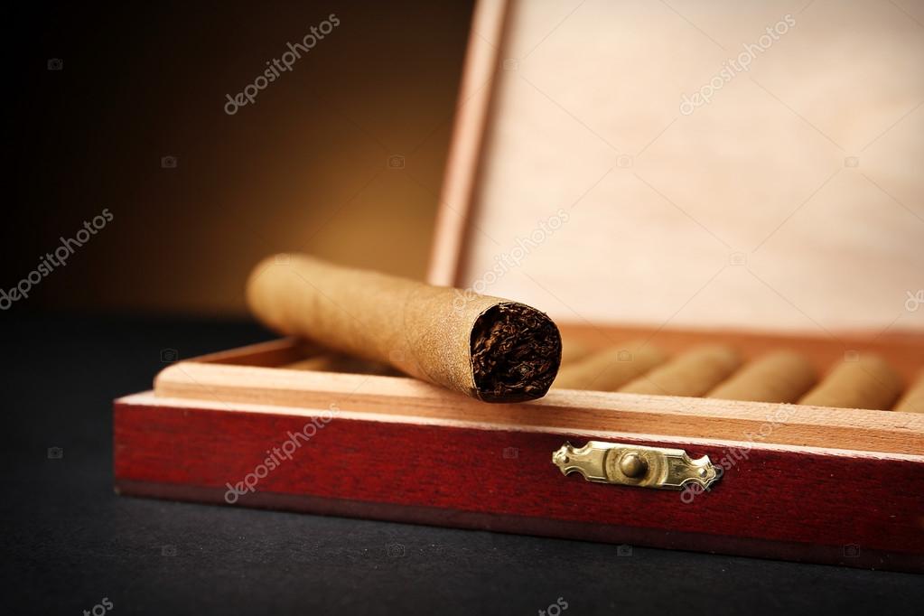 Cigars in box on table, closeup — Stock Photo © belchonock #79660698