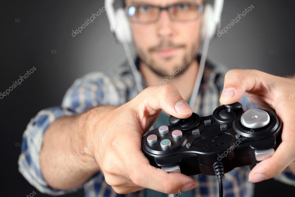 Young man playing video games — Stock Photo © belchonock #80210894