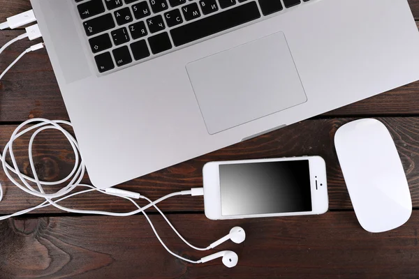 Computer peripherals and laptop accessories on wooden background ...