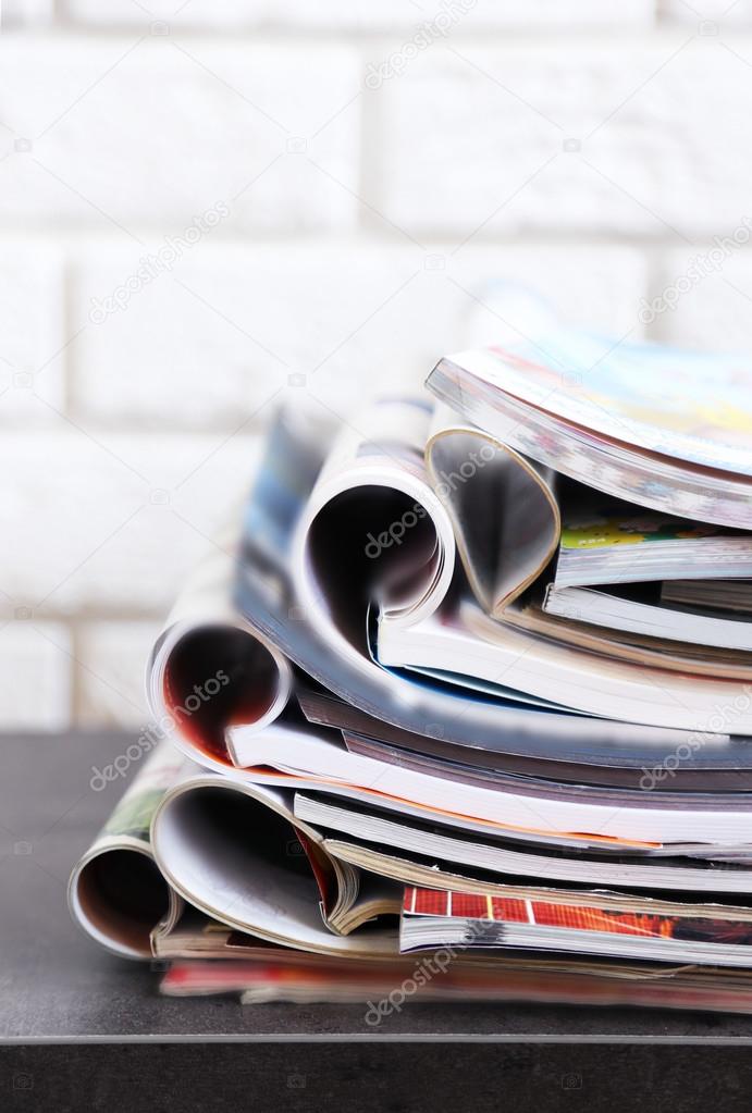 Stack of magazines on table — Stock Photo © belchonock #83870170