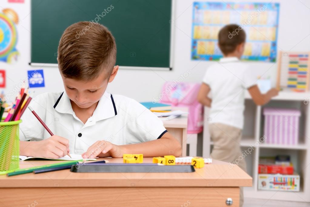 Little boy writing Stock Photo by ©belchonock 83880812