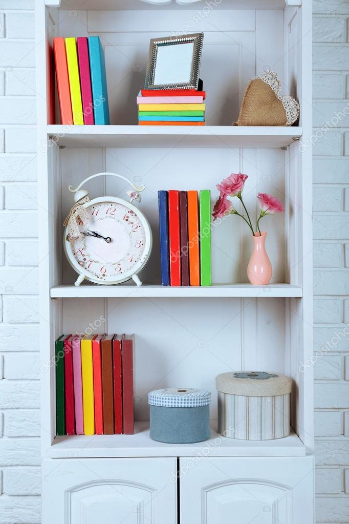 Books and decor on shelves — Stock Photo © belchonock #84783094
