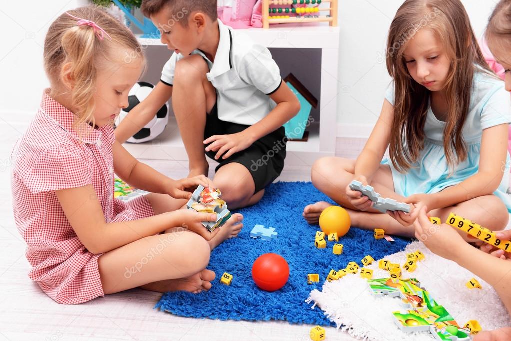 Group of children playing on floor in classroom Stock Photo by ...